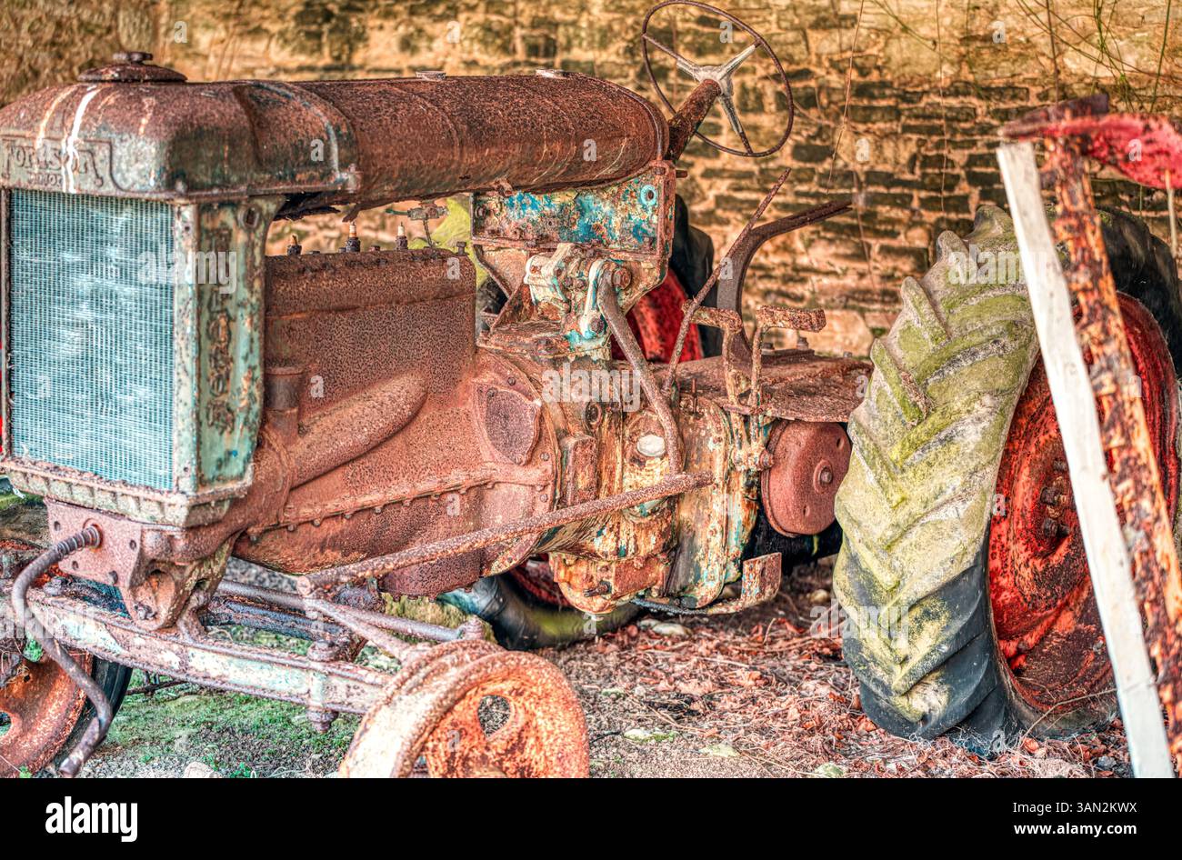 An old tractor in a barn at Tyneham Village, evacuated in 1943 for the ...