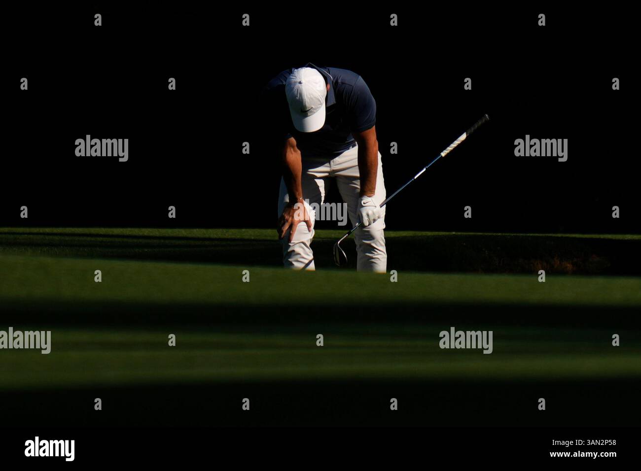 Rory McIlroy, of Northern Ireland, reacts after hitting into the water ...