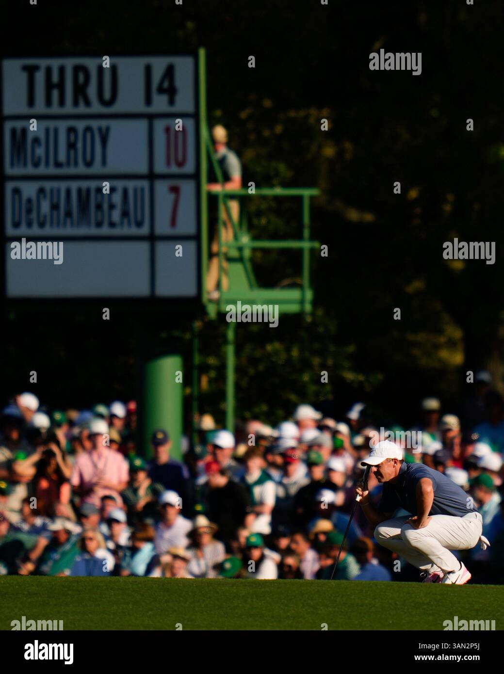 Rory McIlroy, of Northern Ireland, lines up a putt on the 15th hole ...