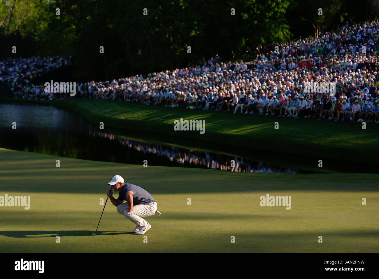 Rory McIlroy, of Northern Ireland, lines up a putt on the 16th hole ...