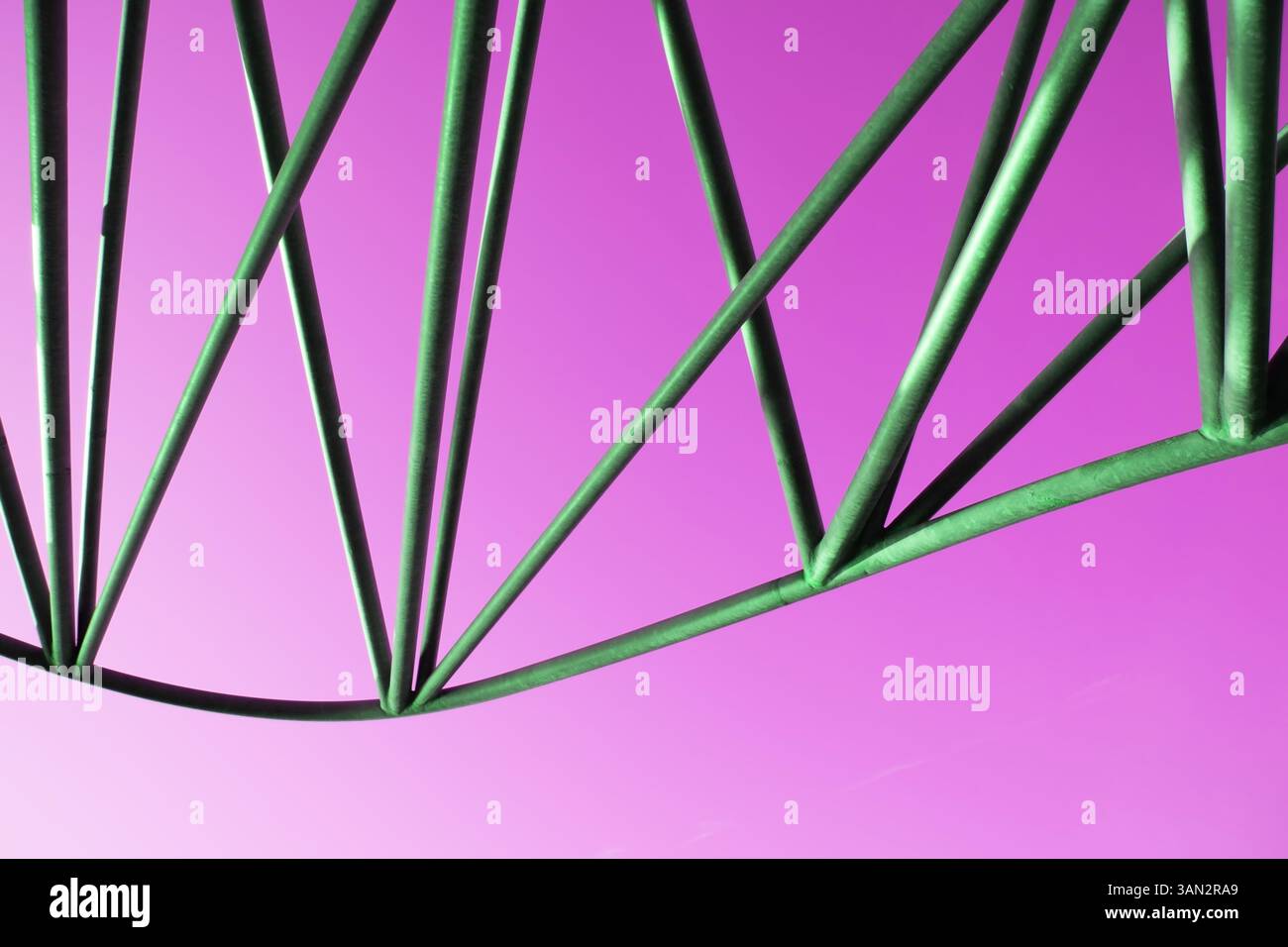 Creative metal art statue made of shiny pipes in front of multicolor ...