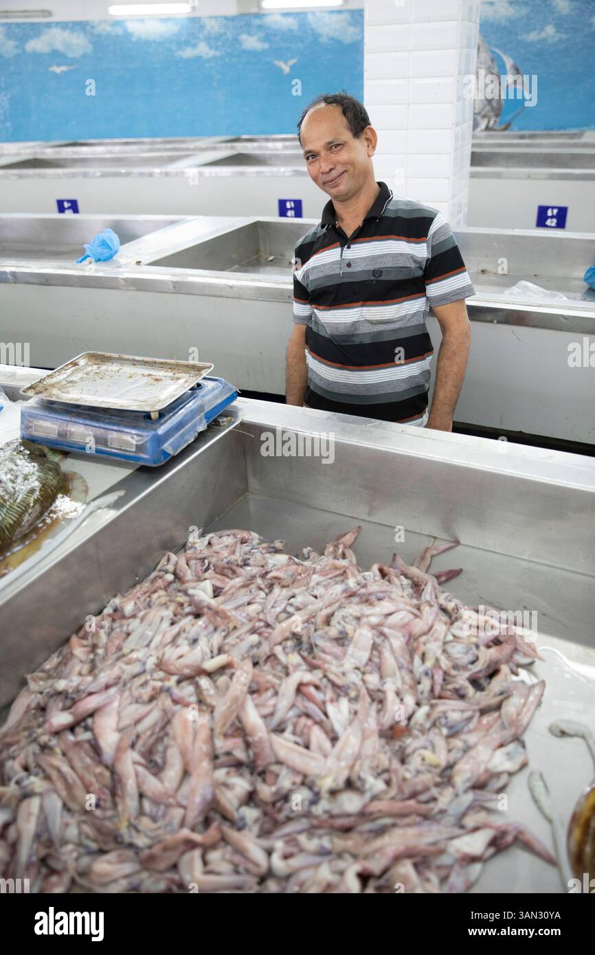 Man selling fish at the Fish Market Mutrah in Muscat Oman close to the ...
