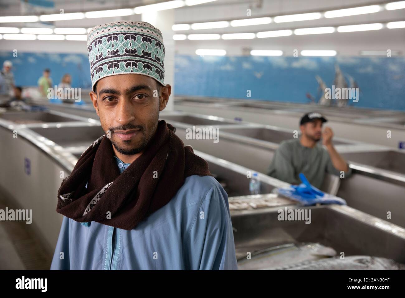 Man selling fish at the Fish Market Mutrah in Muscat Oman close to the ...