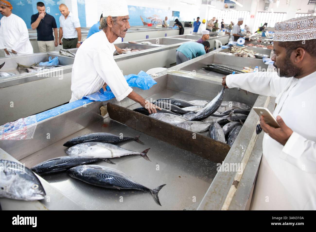Man selling fish at the Fish Market Mutrah in Muscat Oman close to the ...