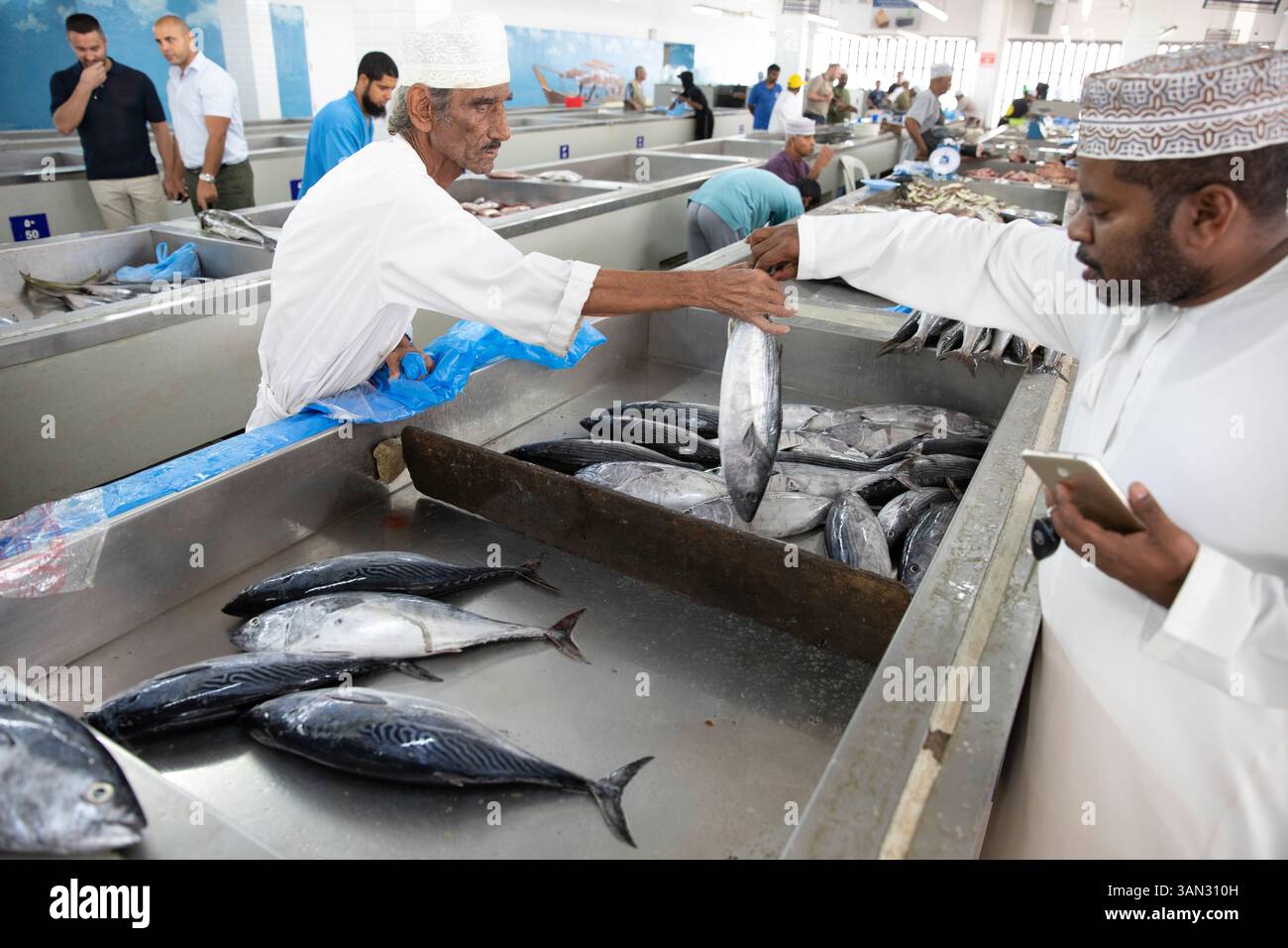 Man selling fish at the Fish Market Mutrah in Muscat Oman close to the ...