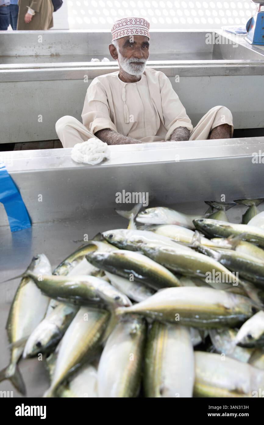 Man with whithe beard selling fish at the Fish Market Mutrah in Muscat ...
