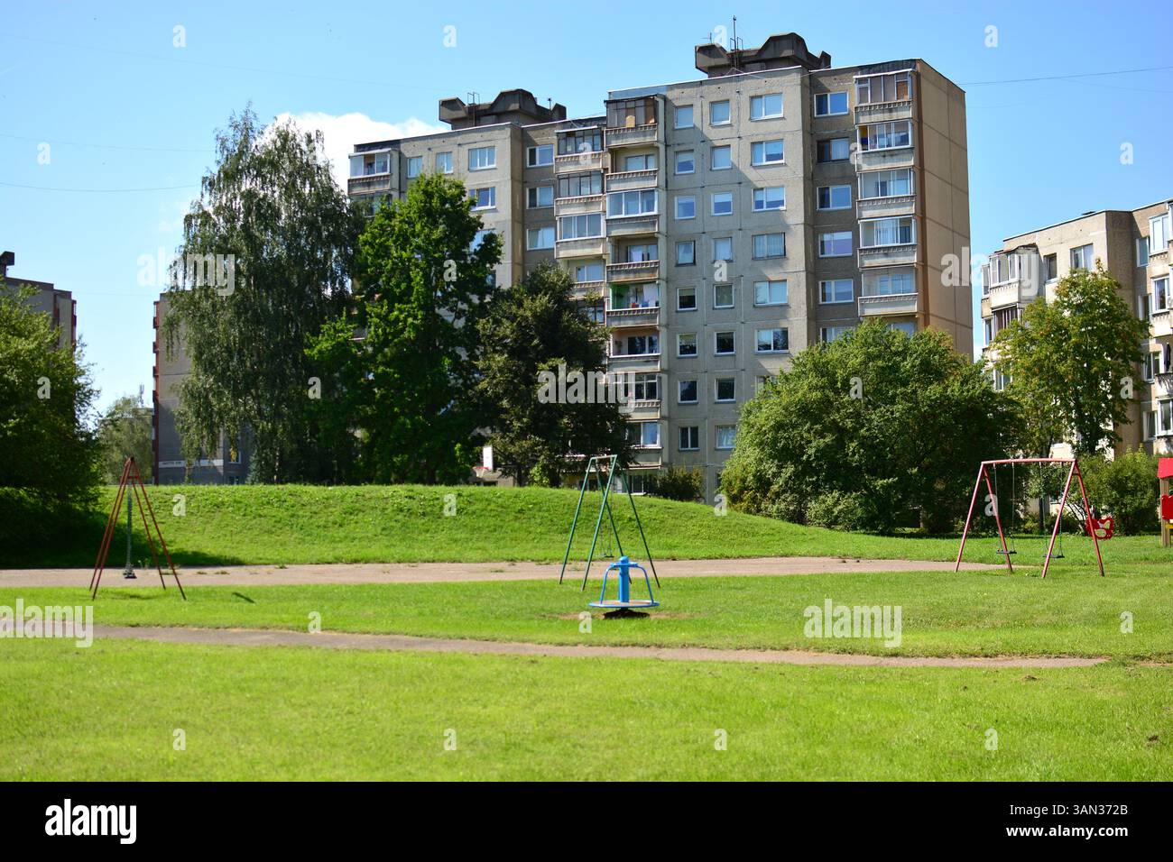 Children playground area near old soviet apartment houses in sunny ...