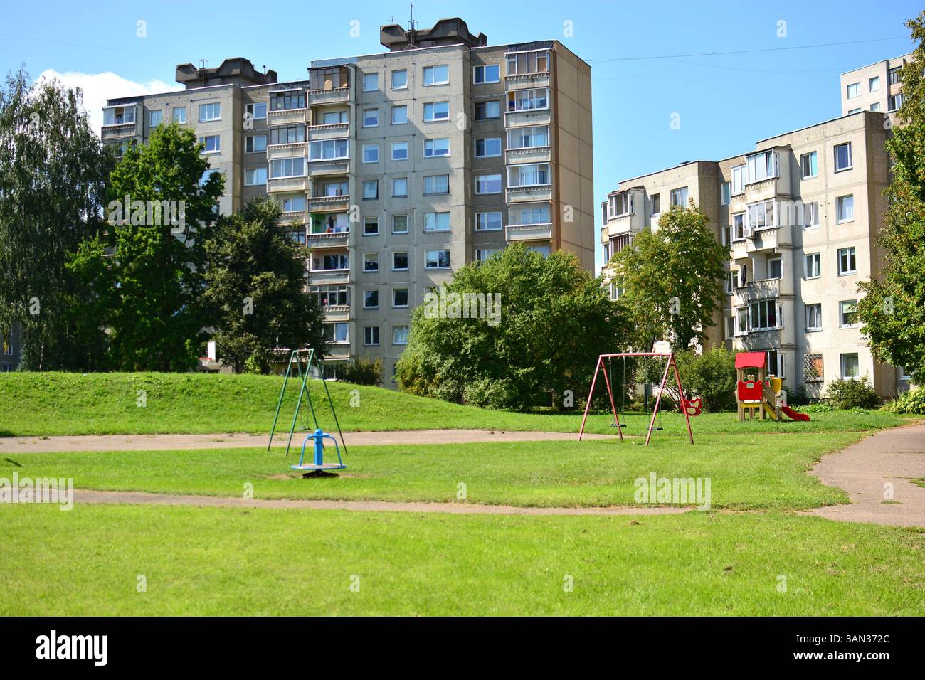 Children playground area near old soviet apartment houses in sunny ...
