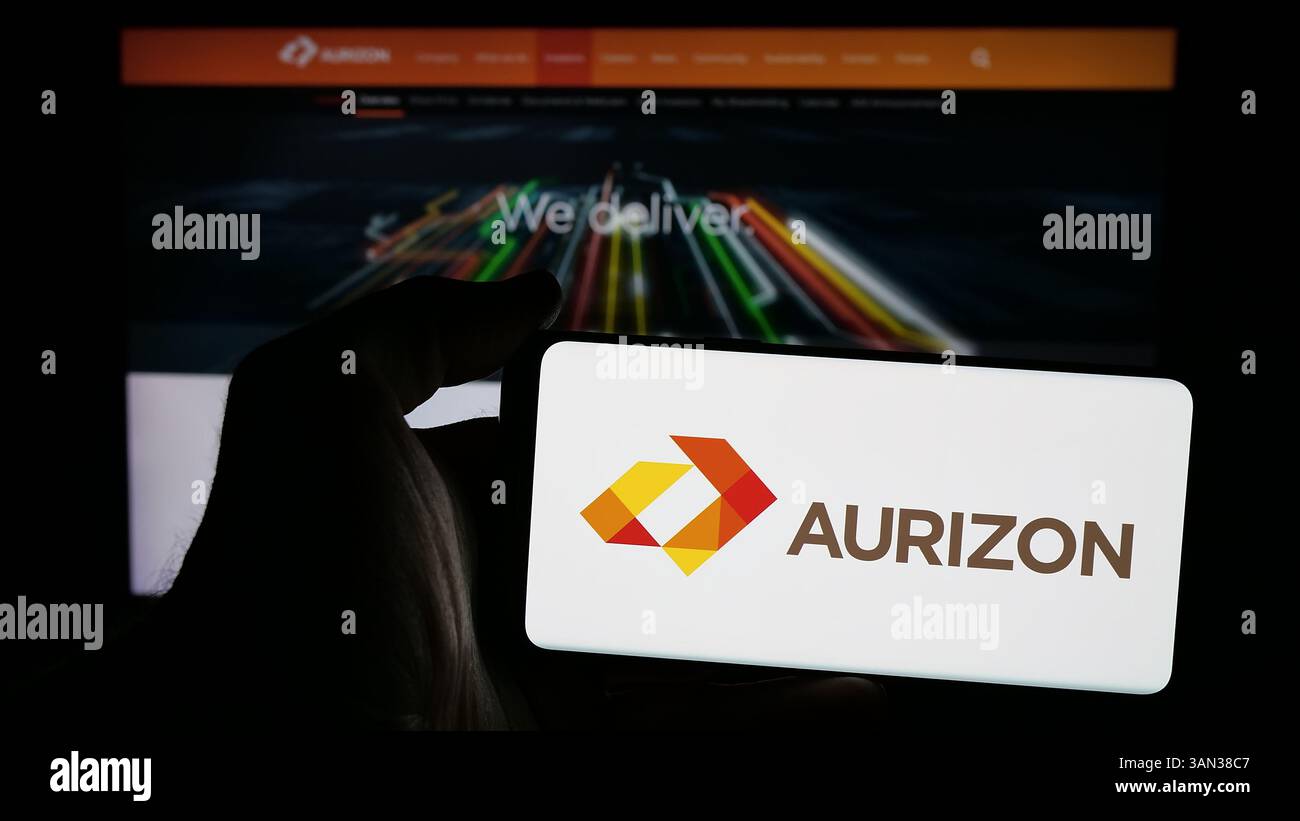 Stuttgart, Germany - 11-28-2024: Person holding mobile phone with logo of Australian freight ...