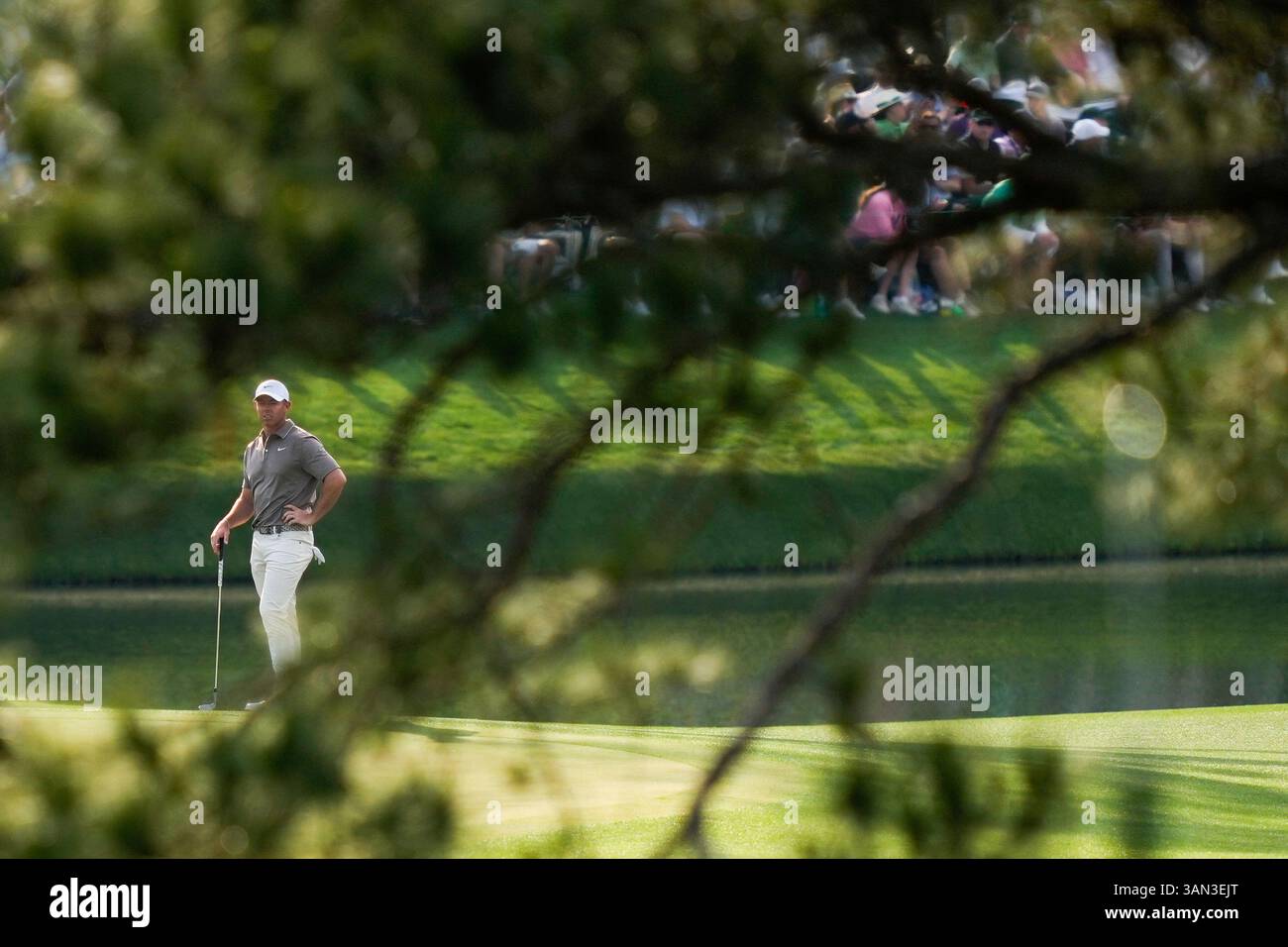 Rory McIlroy, of Northern Ireland, stands on the green of the 17th hole ...