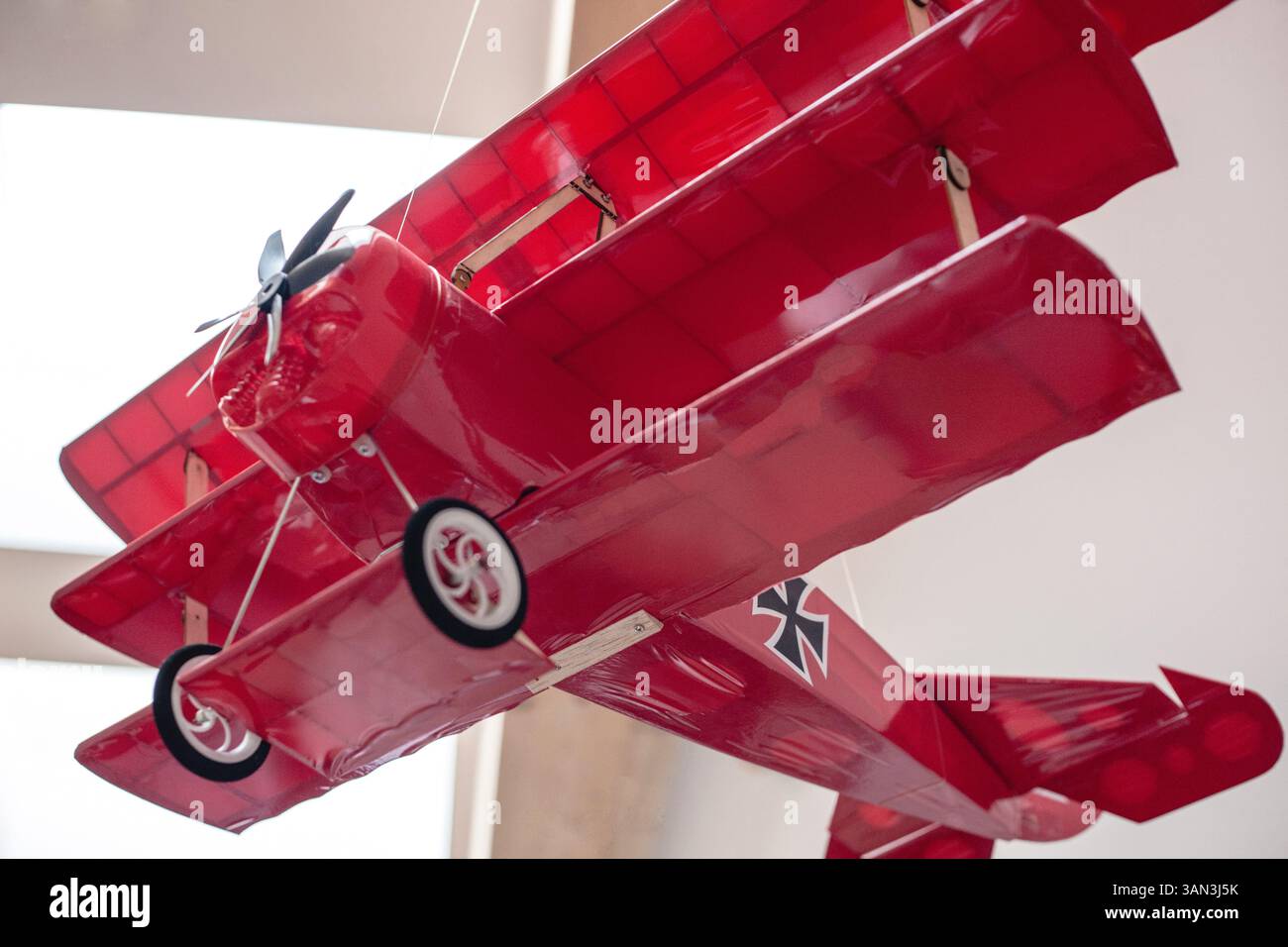 Small red baron plane hanging as a decoration on white background Stock ...