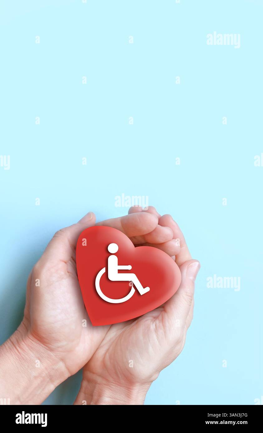 International Disability Day. Female's hand holding a heart with ...