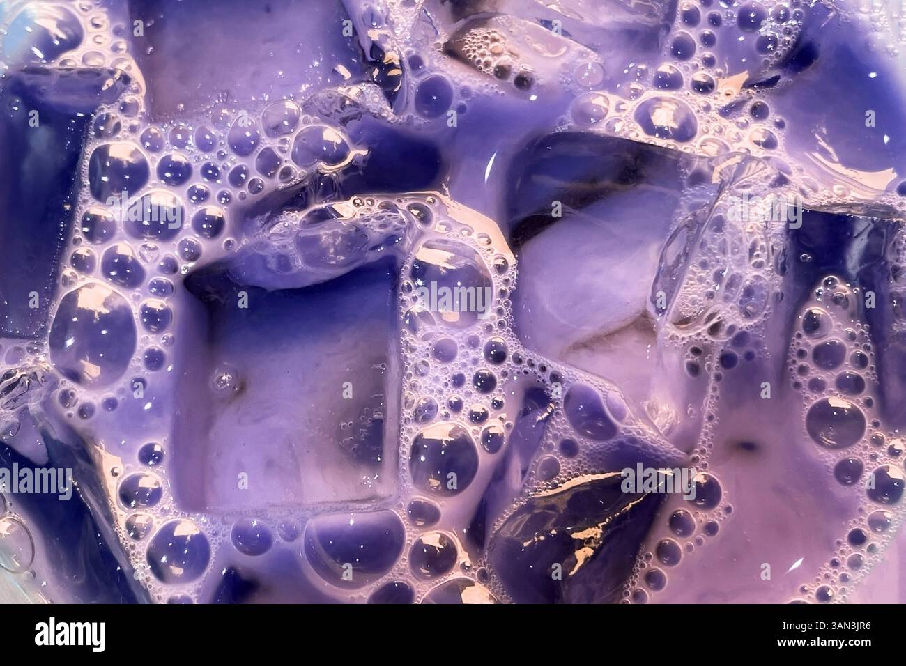 Bright fizzy liquid with floating bubbles and clear ice Stock Photo - Alamy