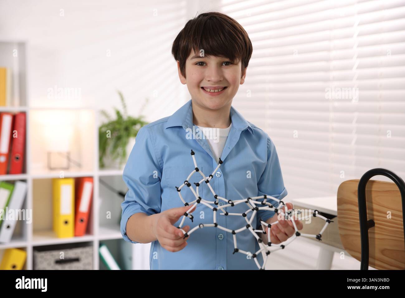 Smiling boy with DNA structure model indoors Stock Photo - Alamy