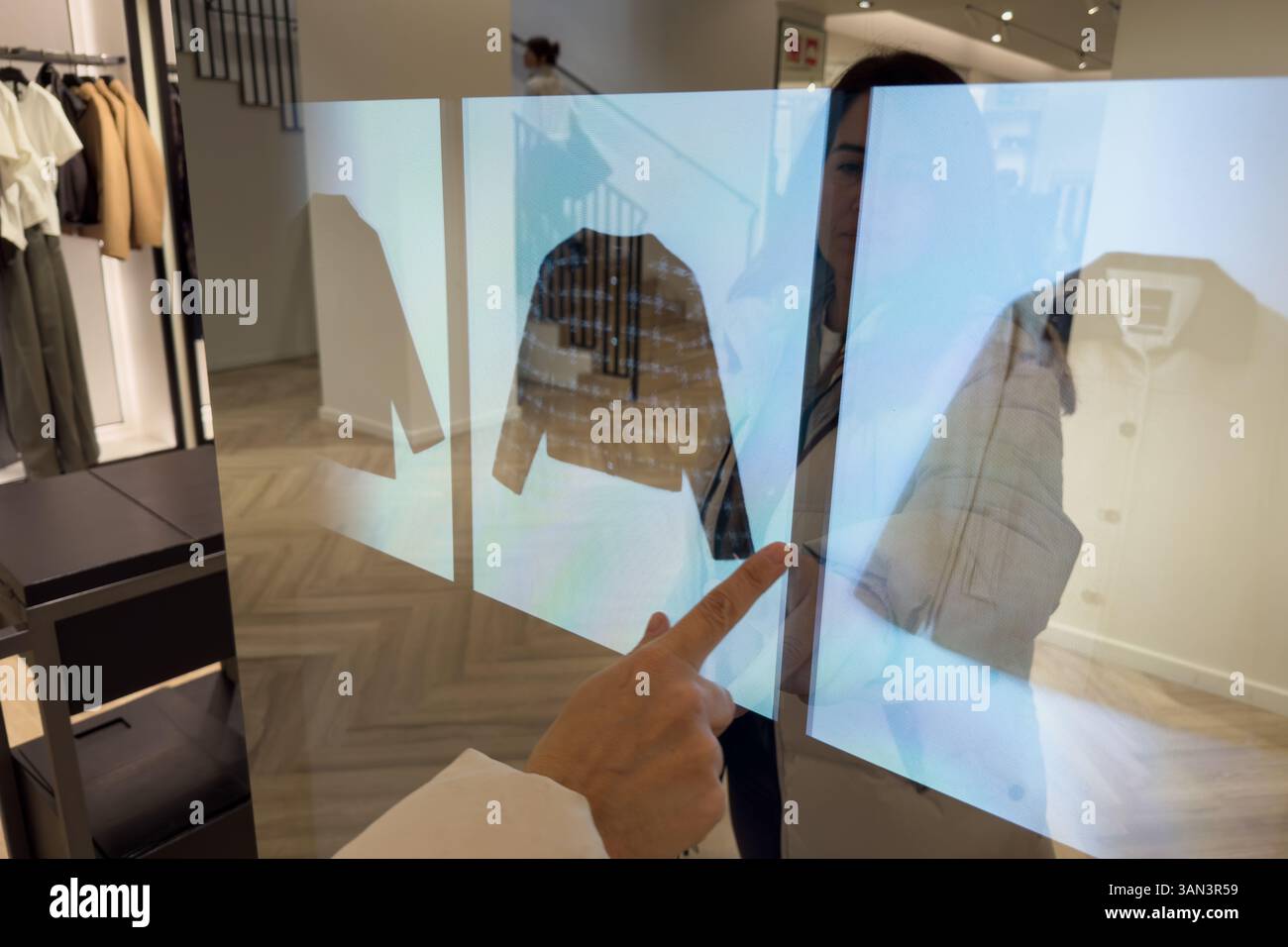 Woman using interactive screen in a fashion store, Zaragoza, Spain ...