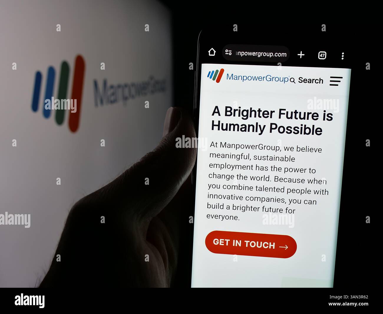 Stuttgart, Germany - 12-02-2024: Person holding cellphone with webpage of US staffing company ...