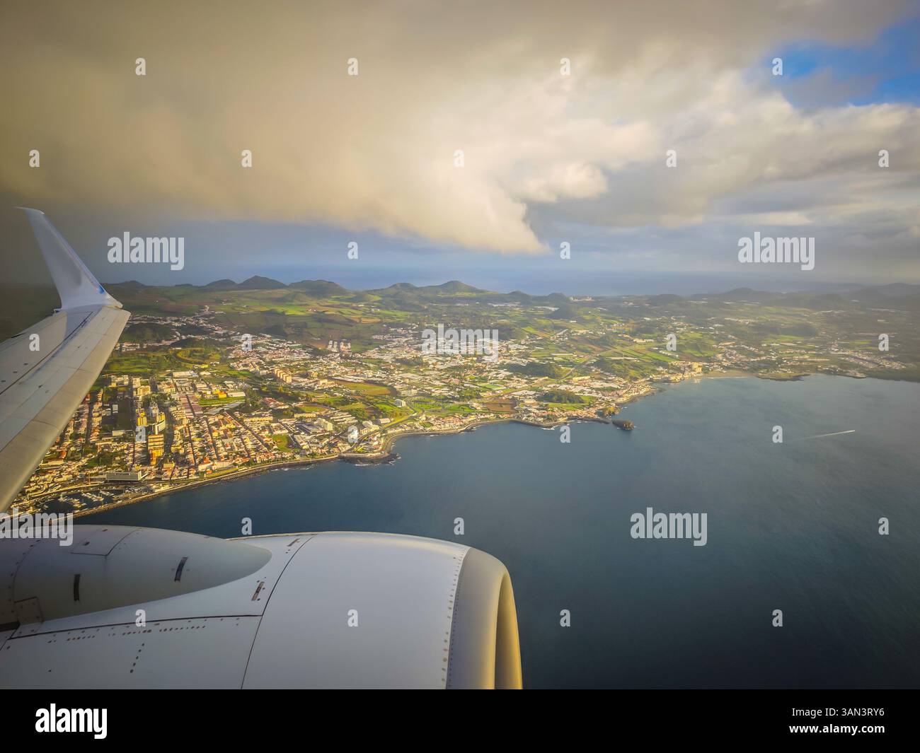 View of a tropical island in the middle of ocean from a plane window ...