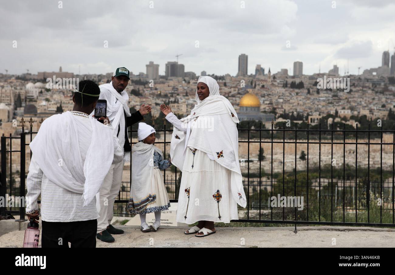 Ethiopian Christian family, pilgrims wearing white take photos of the ...