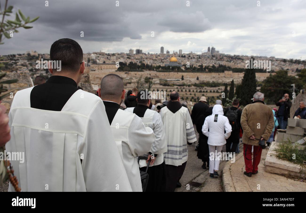 Christian pilgrims walk down from Mt. Olives in a Palm Sunday ...