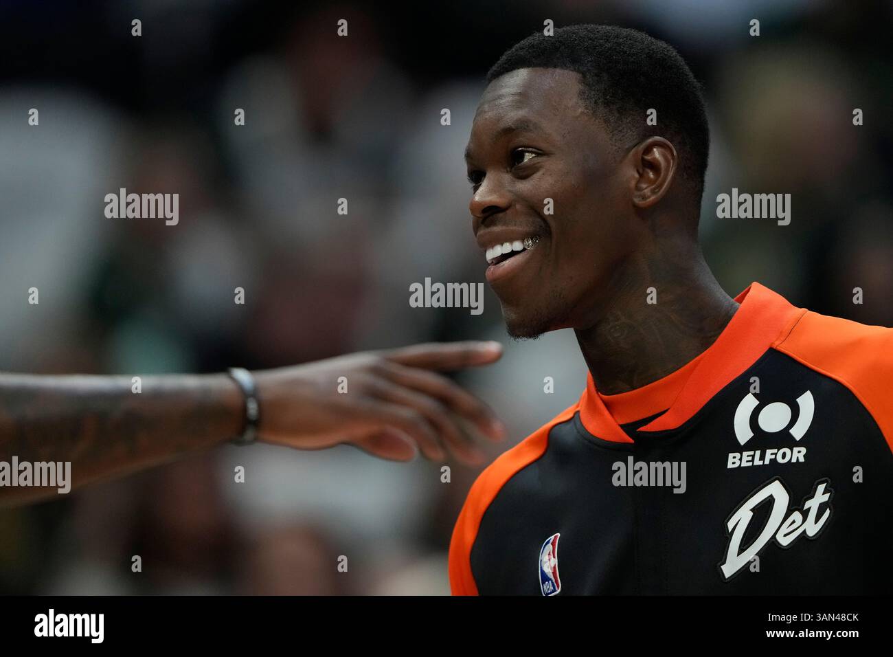 Detroit Pistons' Dennis Schroder smiles from the bench during the first ...
