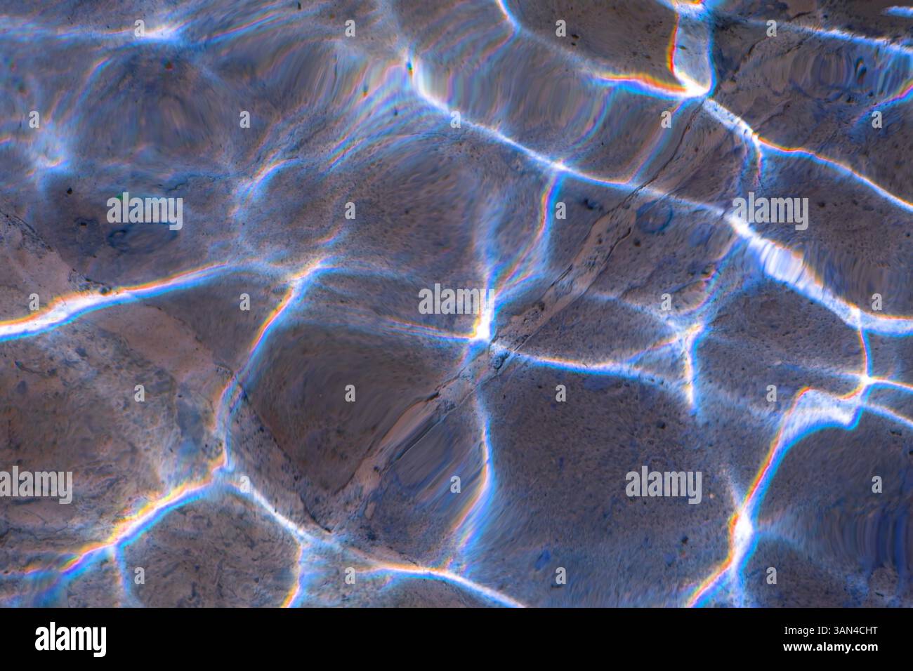 Radiant sun on water in textured stone fountain Stock Photo - Alamy