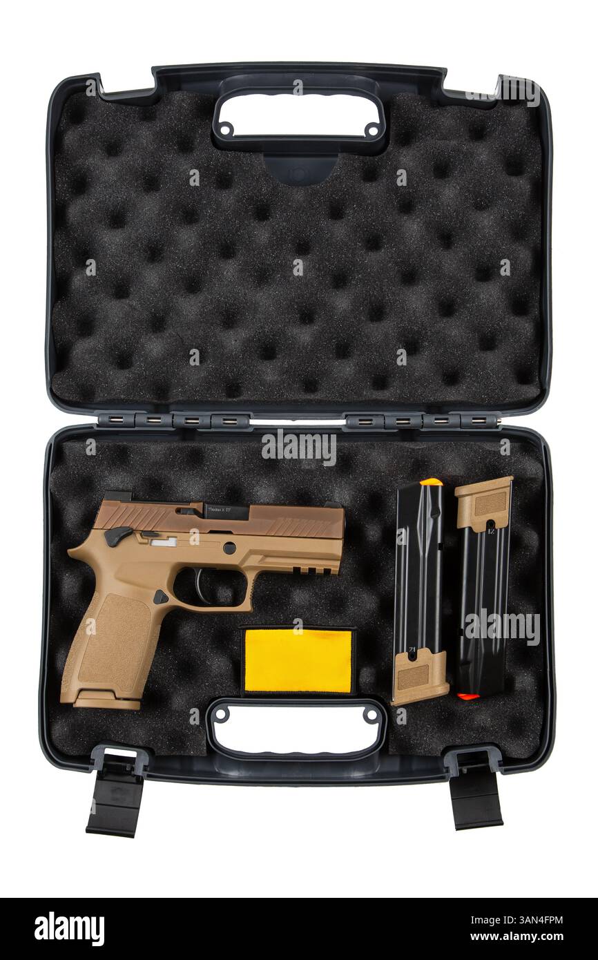 Tan tactical pistol with two magazines in black foam-lined hard case ...