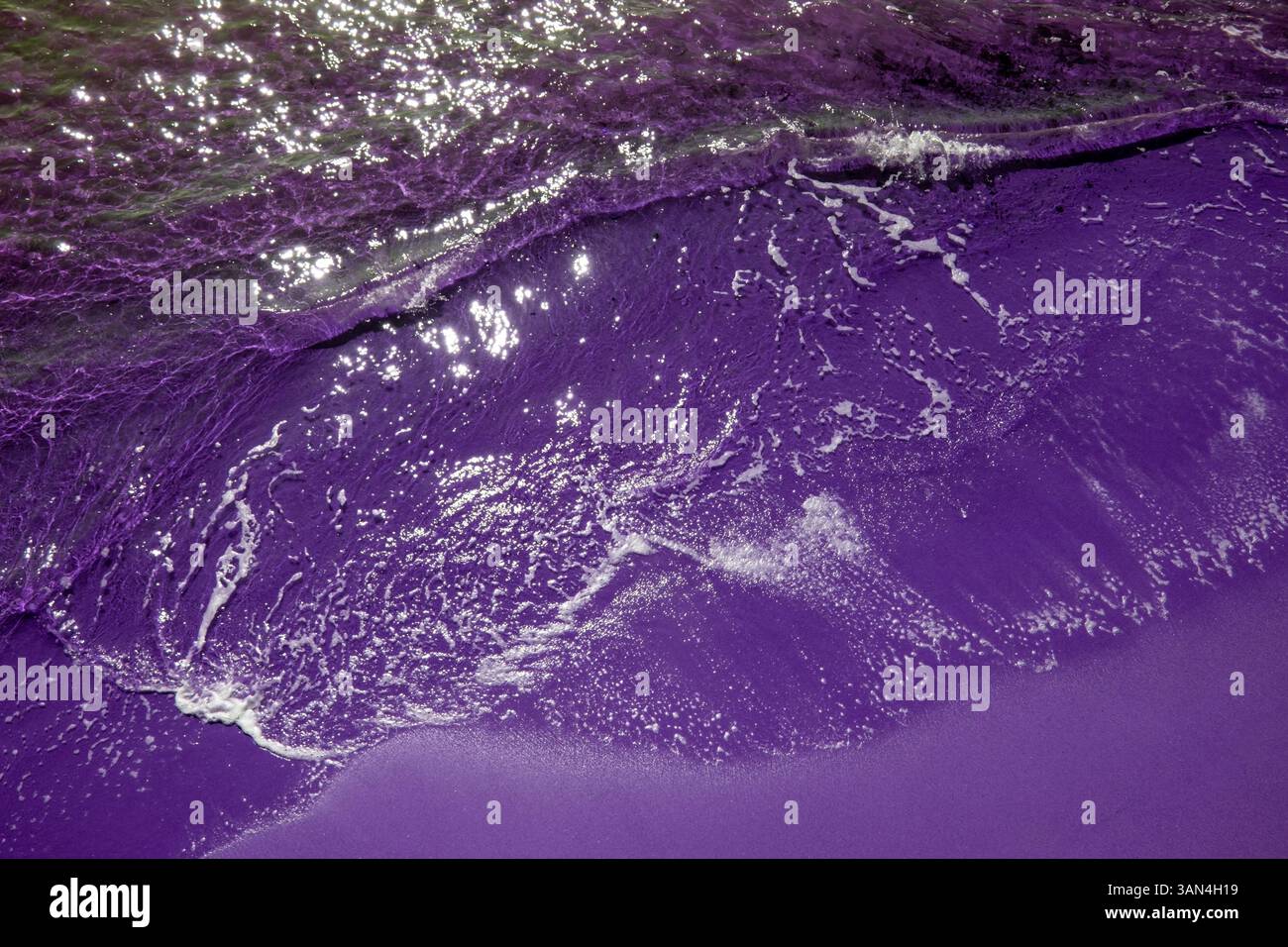 bright blue ocean water flowing across golden beach with rippled wave ...