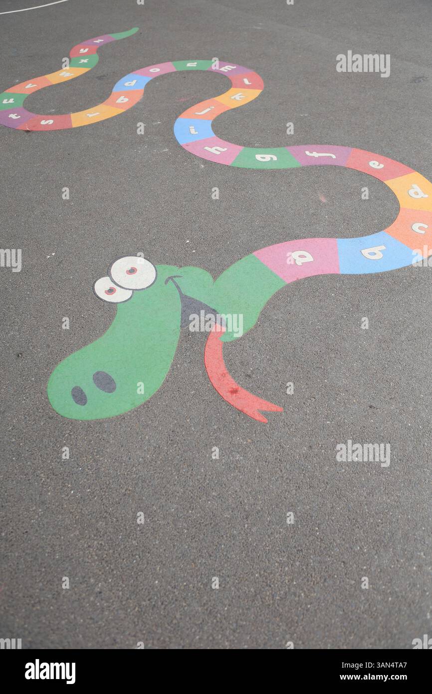 Snake with letters of the alphabet painted on school playground tarmac ...