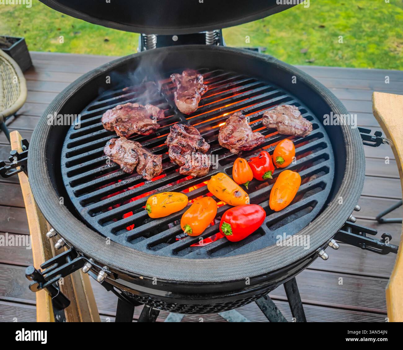 A kamado egg type barbeque grill standing on a living house terrace ...