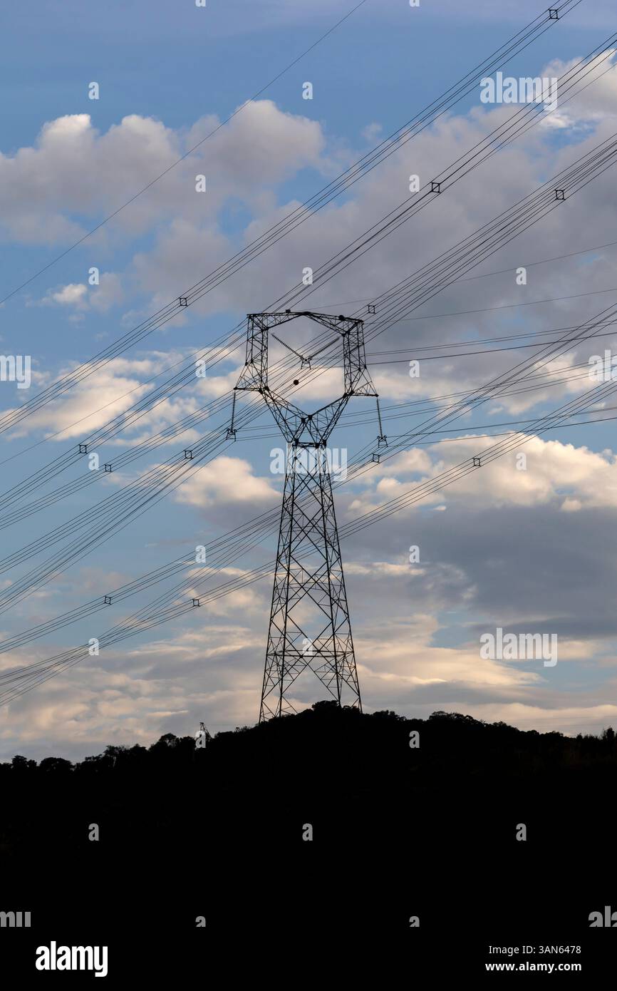Silhouette of electric power towers during dusk. Sunset with blue sky ...