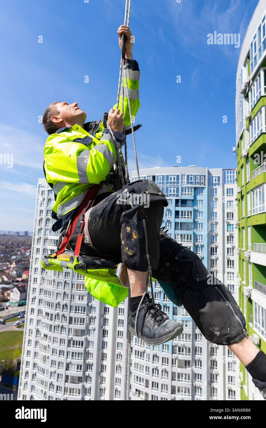 A Skilled Worker Engaged in High-Rise Building Maintenance ...