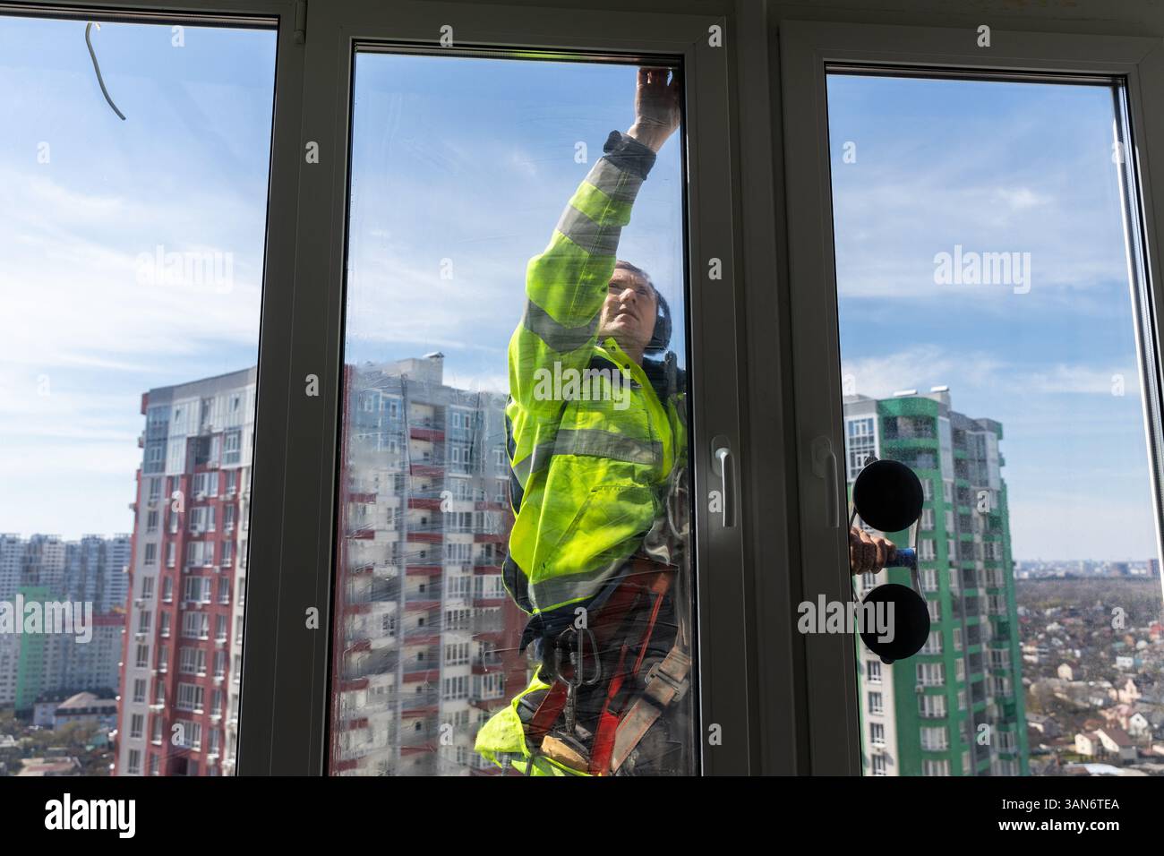 High-Elevation Window Cleaner Performing Cleaning Tasks on a ...