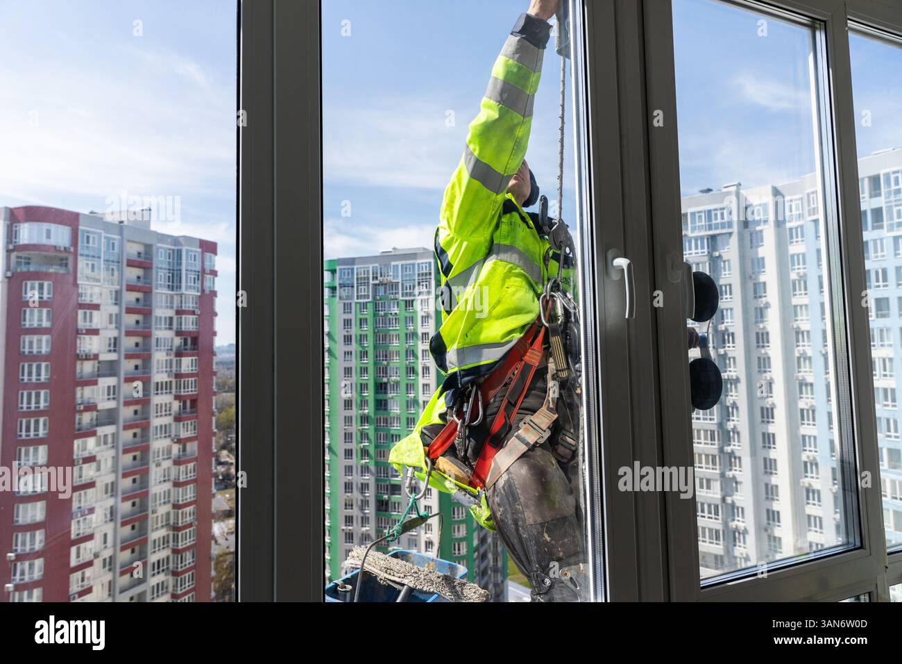 High-Rise Window Cleaner at Work: A Candid Moment Captured in the ...