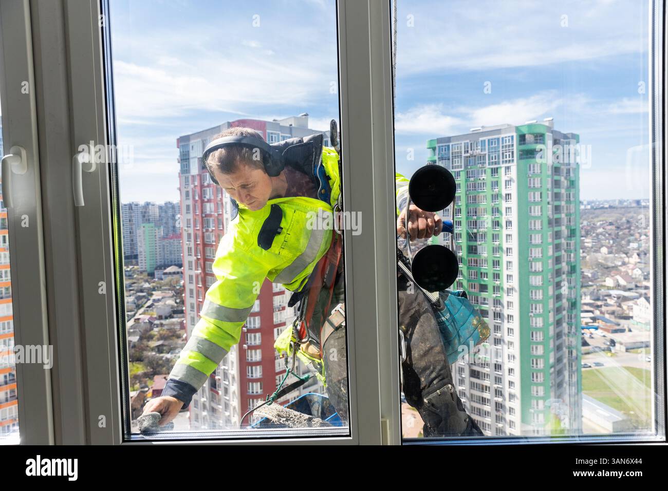 High-Rise Window Cleaner Performing His Duties with Precaution and ...