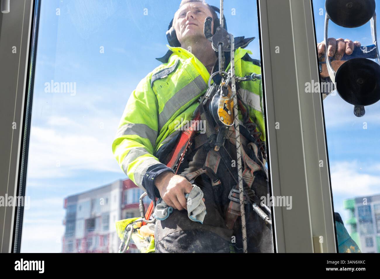 Dedicated Window Cleaner in Safety Gear Performing His Job at Height ...