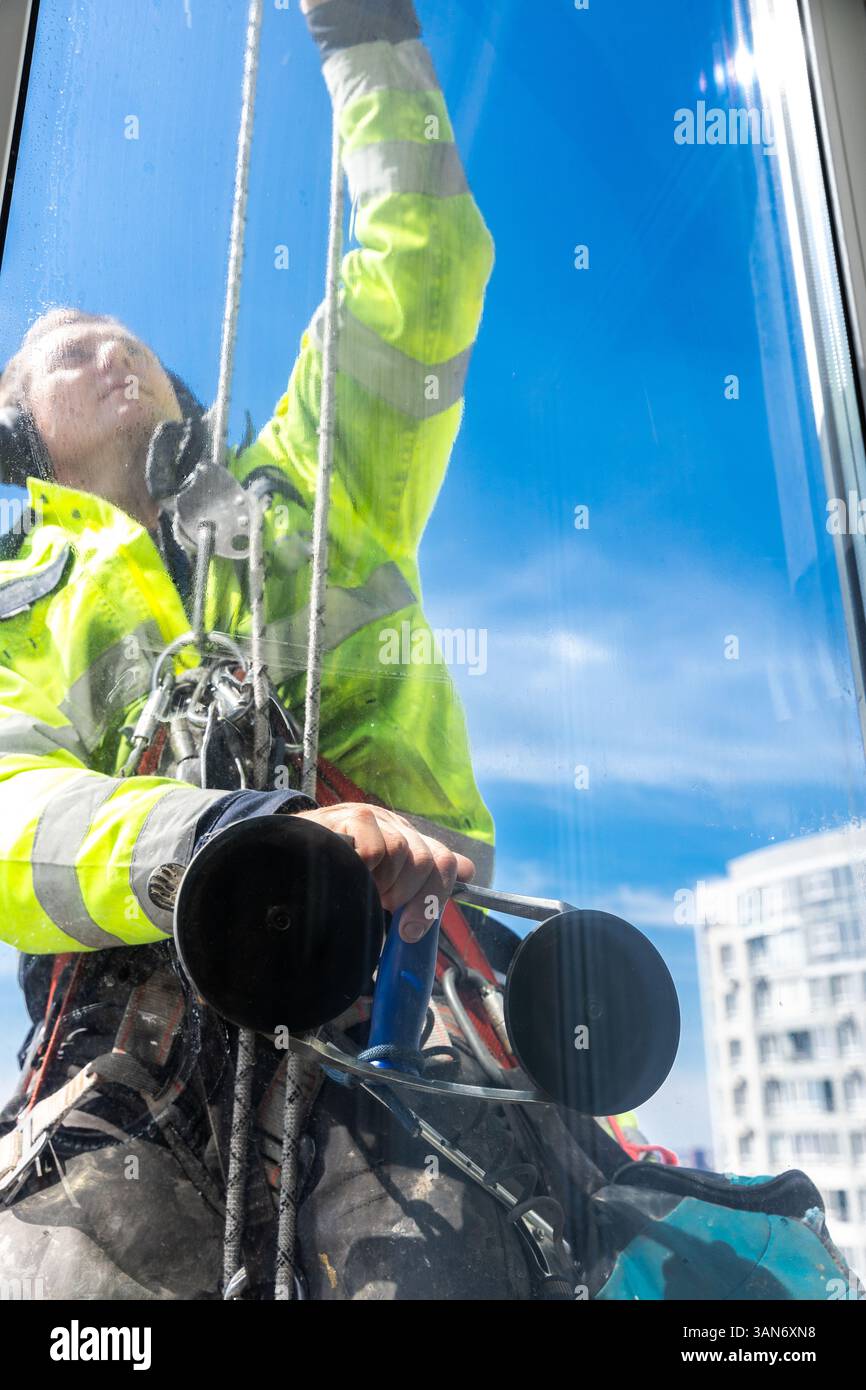 Professional Window Cleaner Working at Height on a Beautiful Sunny Day ...