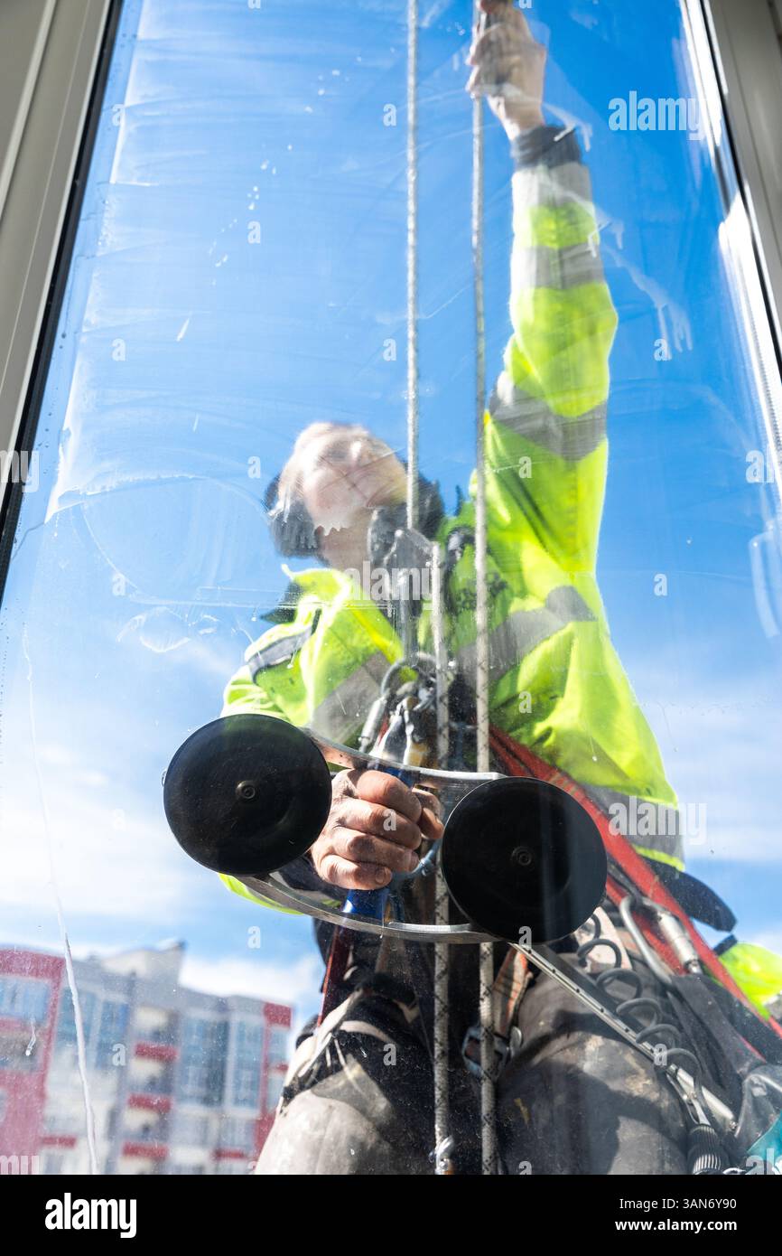 Professional Window Cleaner Man Cleans High-Rise Building Windows with ...