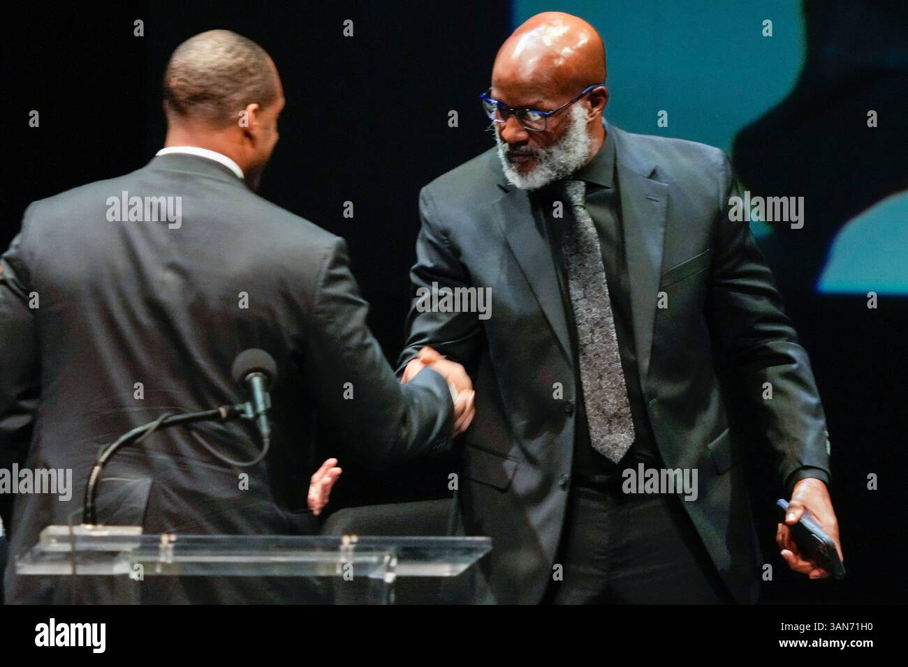 Michael Moorer, former world champion boxer shakes hands with George ...