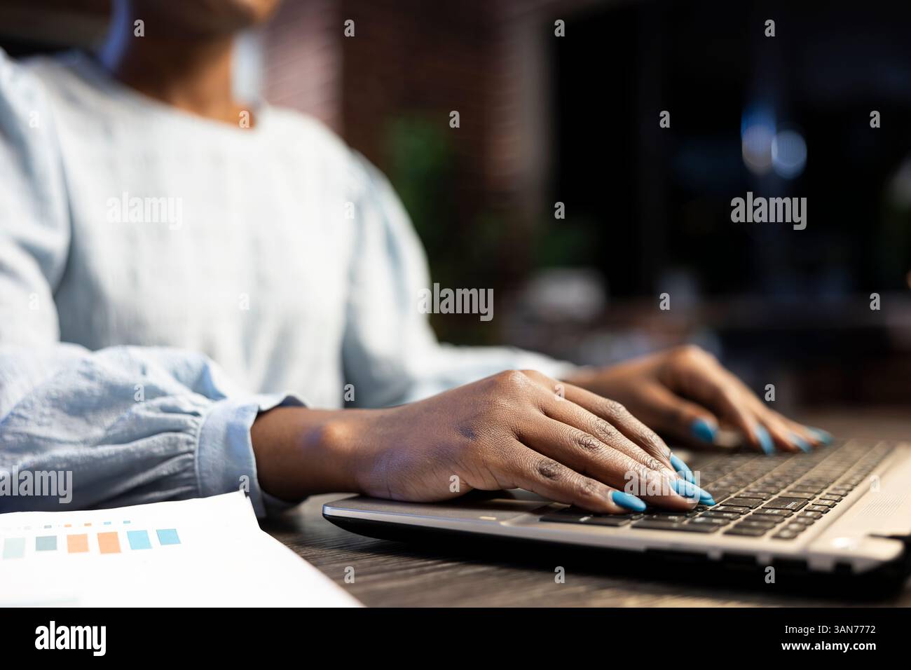 African american businesswoman inputting important data on her personal ...
