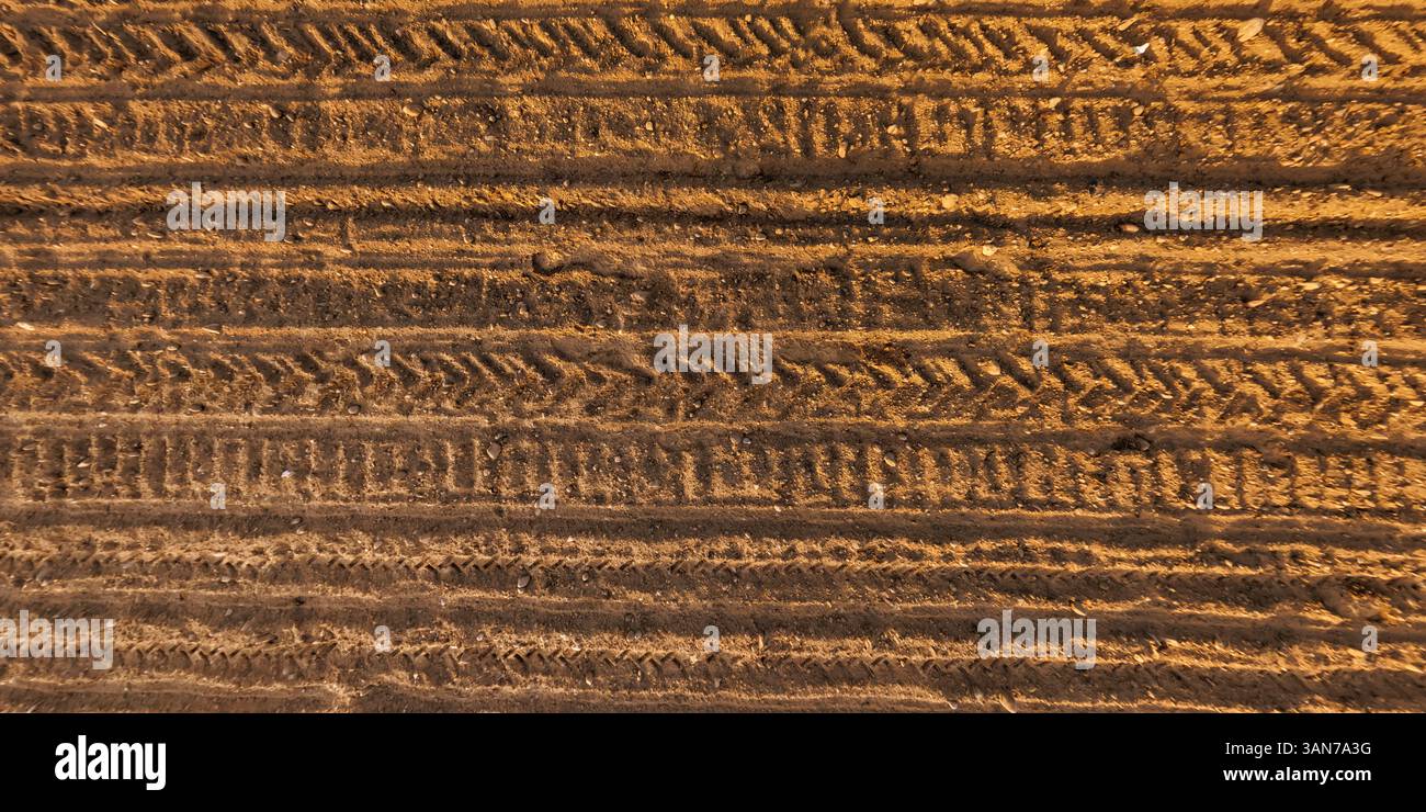 view from above on surface of texture of dry road with tractor tire ...