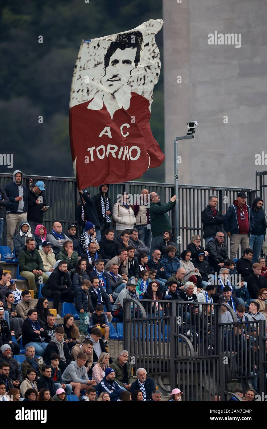Como, Italy. 13th Apr, 2025. Torino FC fans wave a giant flag bearing ...