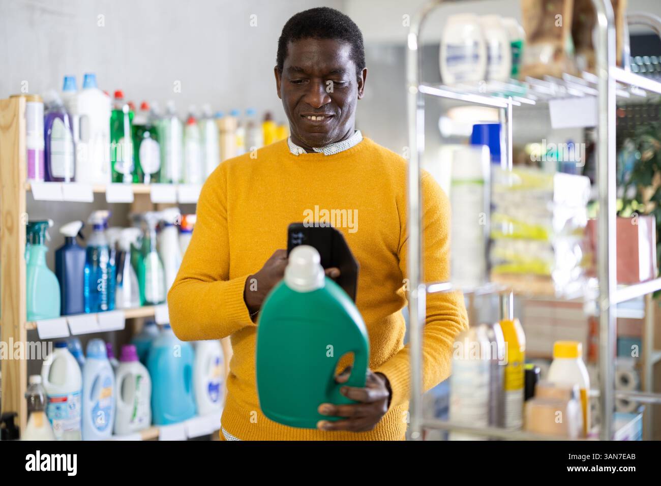 Before making purchase, African man buyer scan QR code on packaging of ...