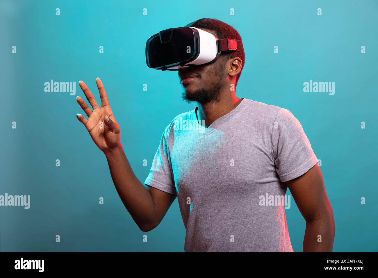 African american man raising his hand while experiencing an advanced VR ...