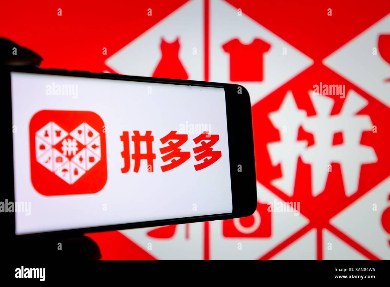 CHONGQING, CHINA - APRIL 14, 2025 - A Pinduoduo logo is displayed on a ...