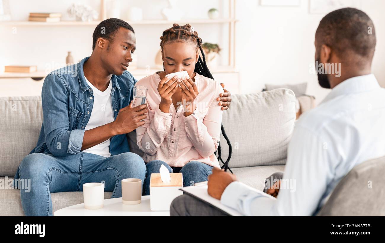 Caring Black Husband Comforting Crying Wife During Therapy Session At ...