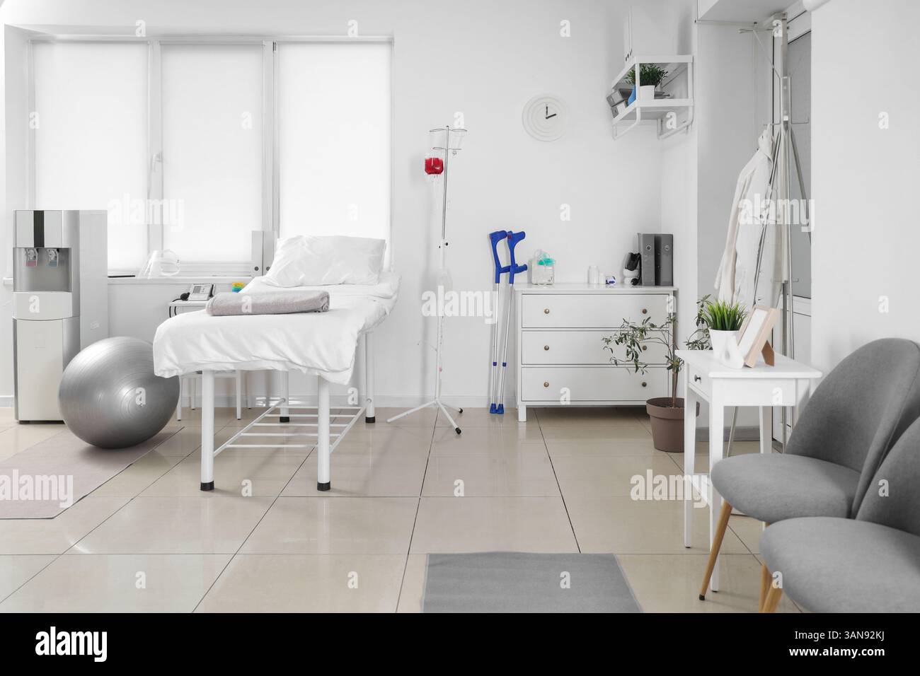 Interior of hospital ward with bed, drawers and cooler Stock Photo - Alamy