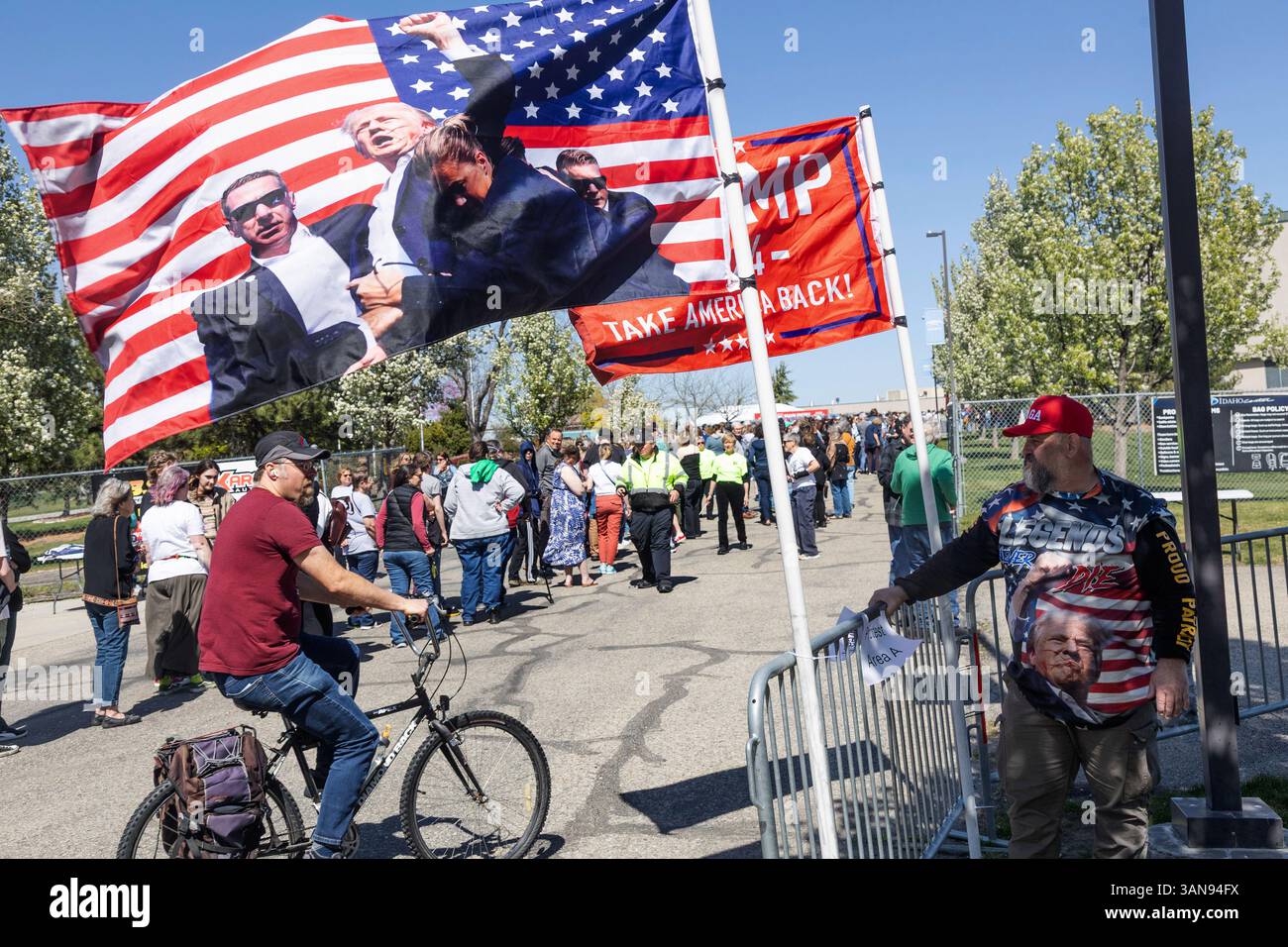Michael Thompson, of Nampa, right, stands by a pair of President Donald ...
