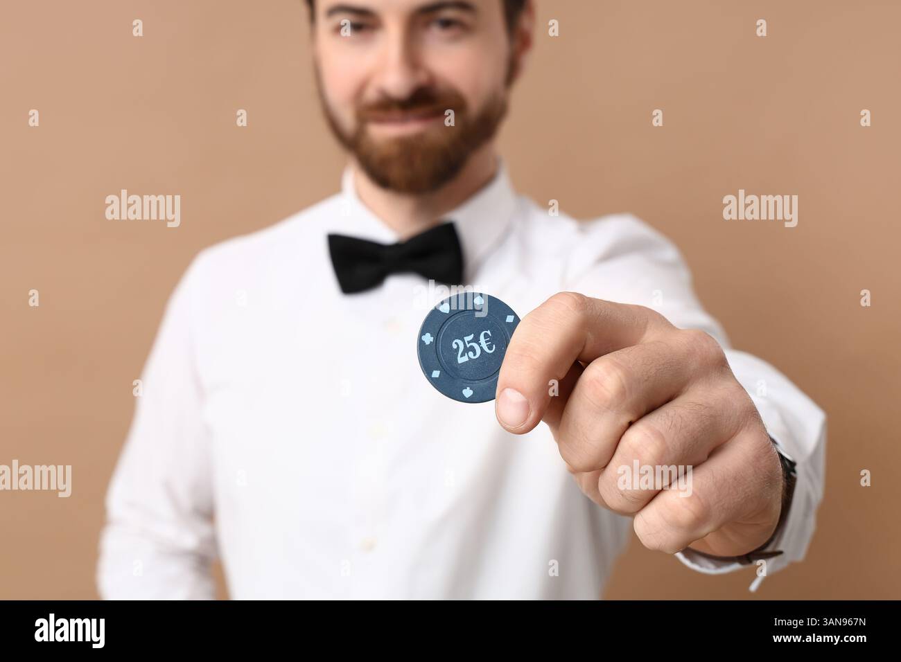 Handsome male banker with poker chip on beige background, closeup Stock ...
