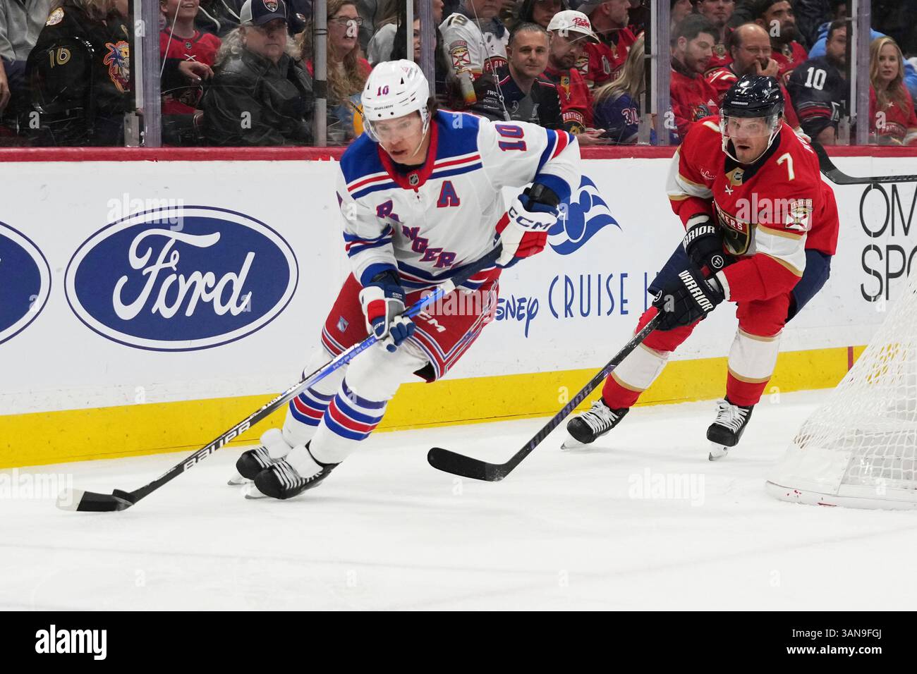 New York Rangers left wing Artemi Panarin (10) skates with the puck as ...