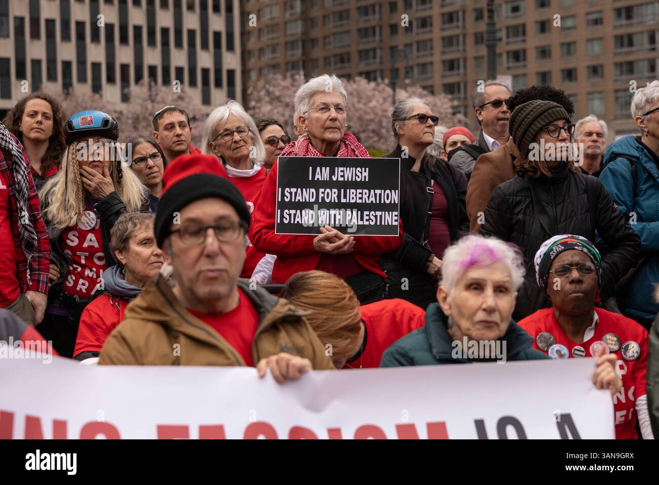 A person holds a sign during a protest by the Jewish Voice for Peace ...
